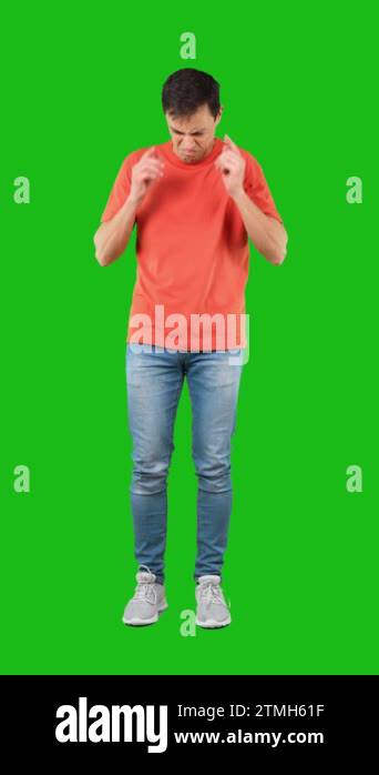 Full body of annoyed male model covering ears from disgusting noise and ...
