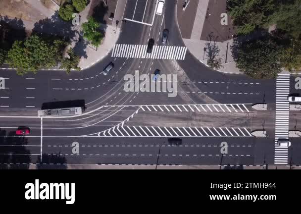 Top down aerial of cars drive at crossroad. City traffic on ...