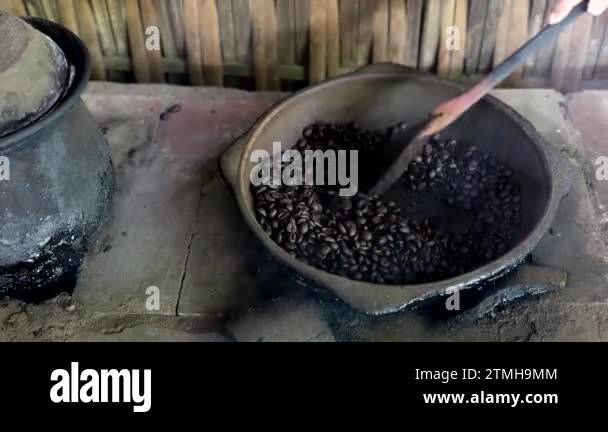 Bali, Indonesia Kopi Luwak beans, or poop coffee, roasting over an open ...