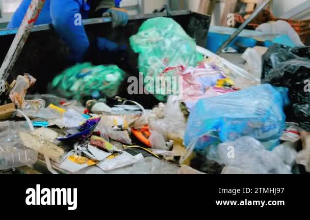 Employee working with garbage moving on a conveyor belt at waste ...