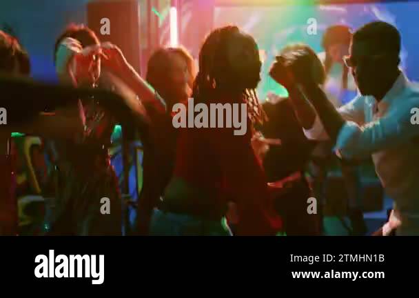 Young people jumping around at club, having fun with cool breakdance ...