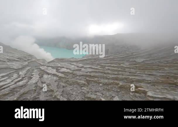 Dramatic aerial view of a crater acid lake Kawah Ijen where sulfur is ...