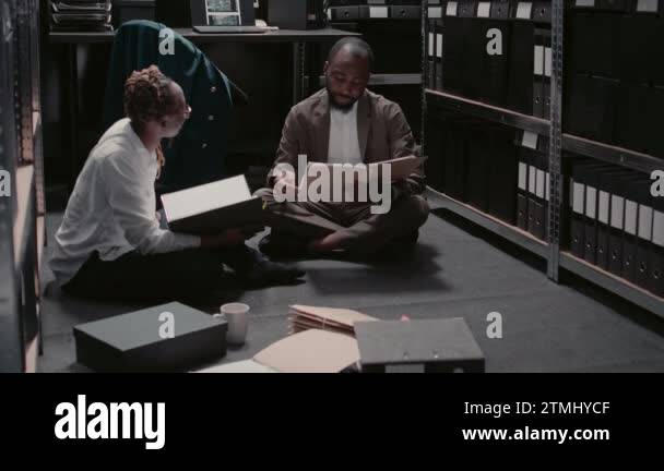 Team of police officers working with forensic evidence to uncover new ...