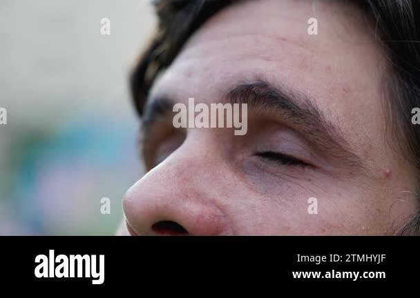 Person closing eyes in contemplation and then opens eye upwards to sky ...