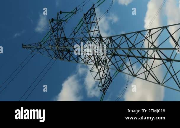Electric power lines and pylon against clear blue sky. Vertical video ...