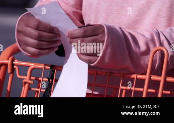 Woman checks paper receipt near shopping grocery store supermarket ...