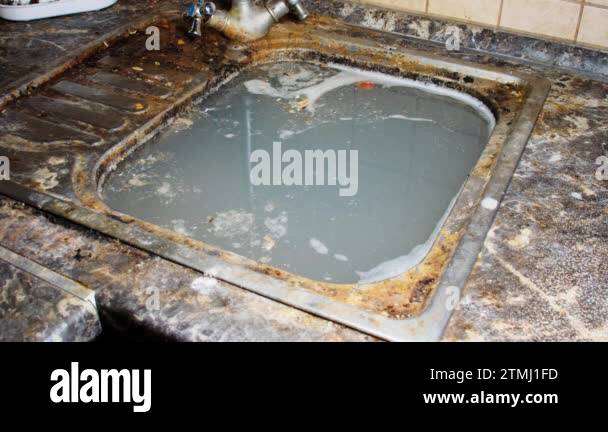 Kitchen sink is full of dirty water. Very dirty kitchen sink with soapy ...