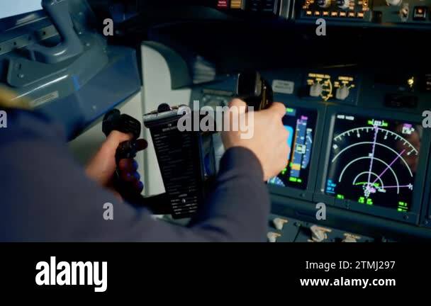 Pilot in airplane cockpit holding turning wheel rudder during flight ...