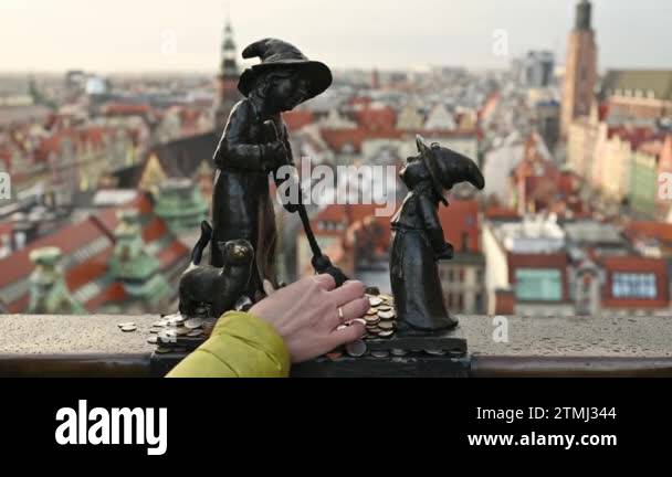 Tourist hand put coins and touch famous dwarf gnome sculpture for lucky ...