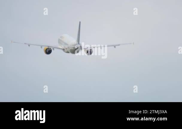 Footage of a jet passenger plane flies away, climb, rear view. Blur and ...