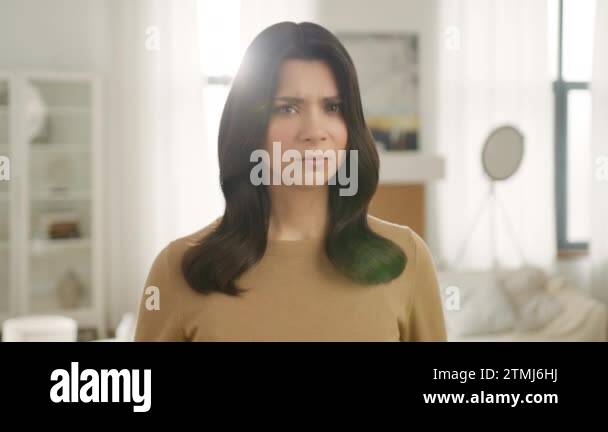 Portrait of beautiful confused woman frowning while listening partner ...