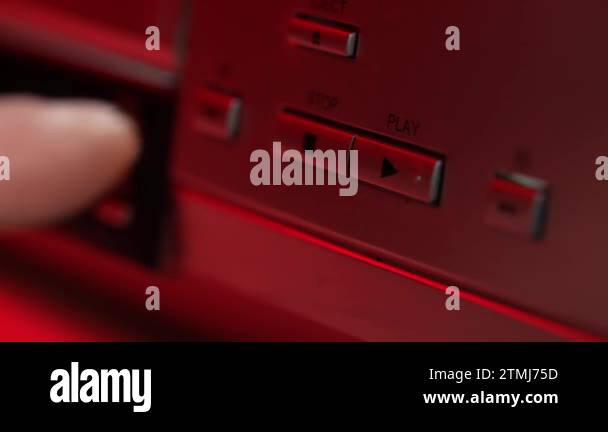 Close-up of a hand pressing the play and stop button on a VHS VCR. 4K ...