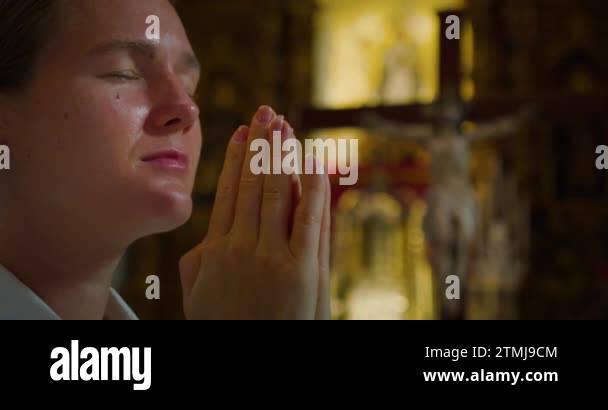 Christian woman prays on her knees in church against the background of ...