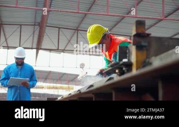Young asian worker using machine welding iron with hands working while ...