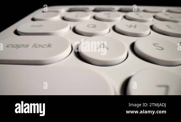 Detailed buttons of modern white keyboard on computer on office table ...