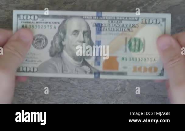 Counting in hands 100 US dollar banknotes of the new model Stock Video ...