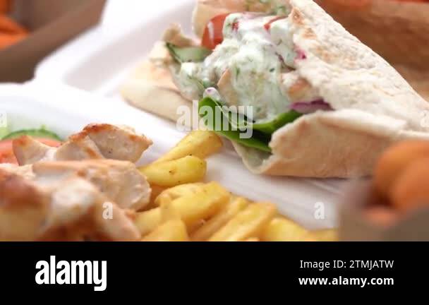 Traditional Greek fast food served on table in a cafe. Gyros sandwich ...