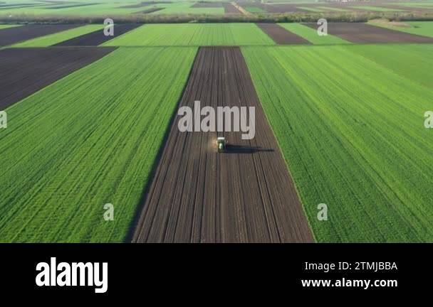 Above view, tilting camera down, dolly move, of tractor as pulling ...