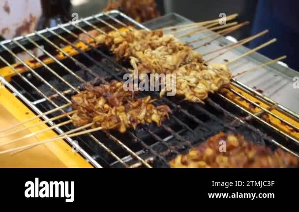 Mushroom satay on the grilled process. Sate is one of the famous ...