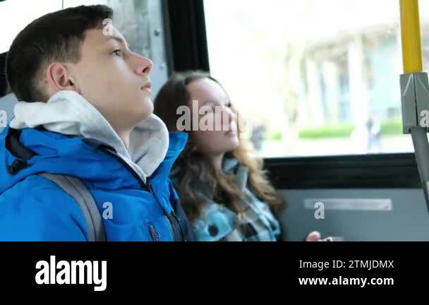 two teenagers in blue clothes sit on a bus Canada Vancouver hoods ...