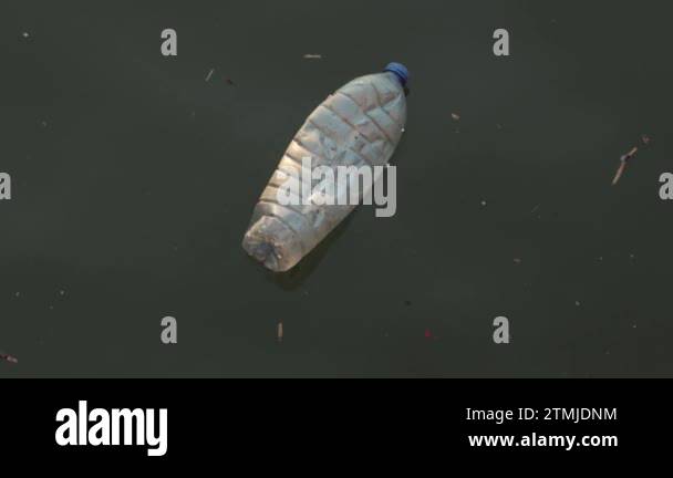 Waste plastic garbage floating on dirty water surface. River pollution ...