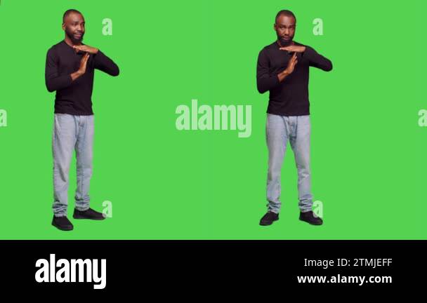 Young model showing timeout symbol in studio, posing over full body ...