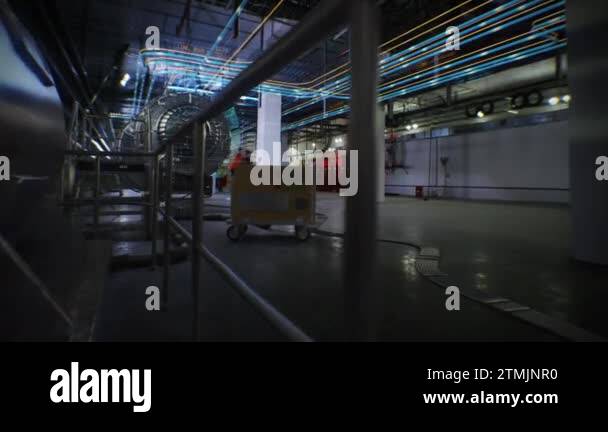 Team of diverse heavy industry workers walks through gas distribution ...