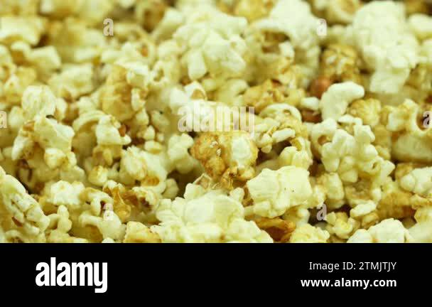 Freshly cooked popcorn with butter rotating. Popcorn background. Cinema ...