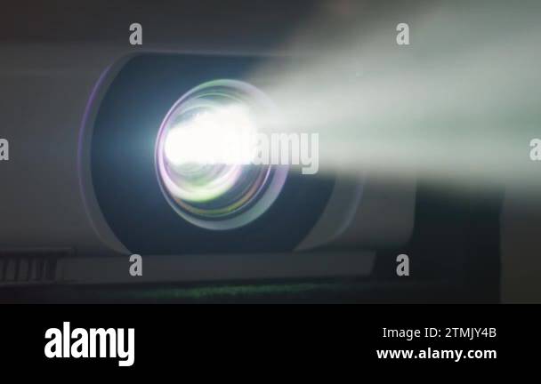 Projector colourful beams blinding multi-screen in dark room. Spotlight ...
