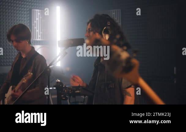 Professional vocalist uses audio mixer and sings lyrical composition ...