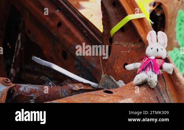 Close-up of a childs toy in ruins after a fire. A soft toy among the ...