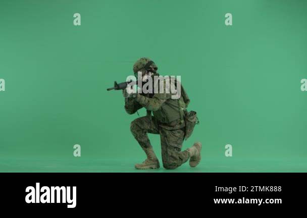Soldier sitting and targeting at green screen Stock Video Footage - Alamy