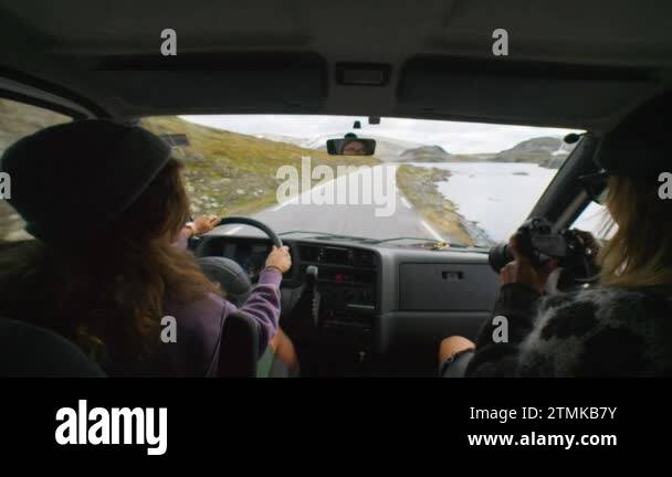 Two friends travel in cosy camper van in amazing landscape in mountains ...