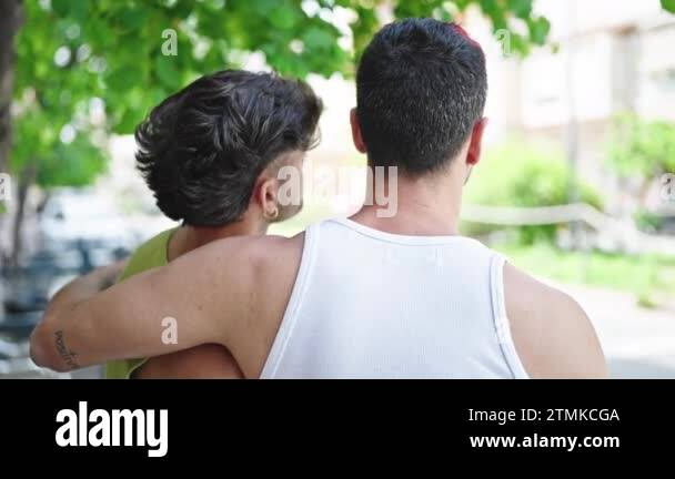 Two men couple hugging each other backwards at park Stock Video Footage ...