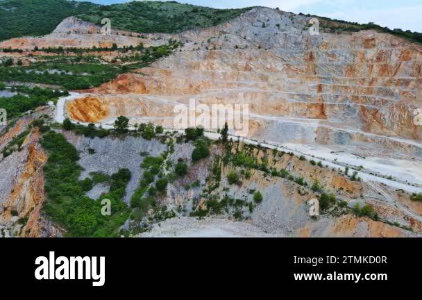 A natural stepped quarry rich in minerals is located near winding road ...