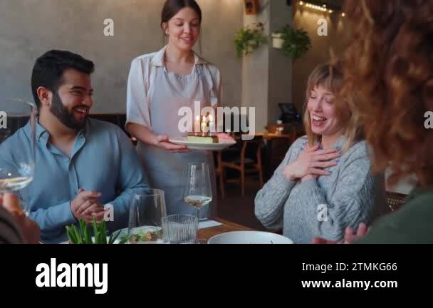 Waitress brings birthday woman cake to celebrate with friends and ...