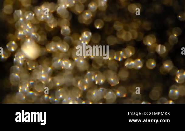 Golden glitter background in slow motion. Beautiful transition with real gold particles. flying ...