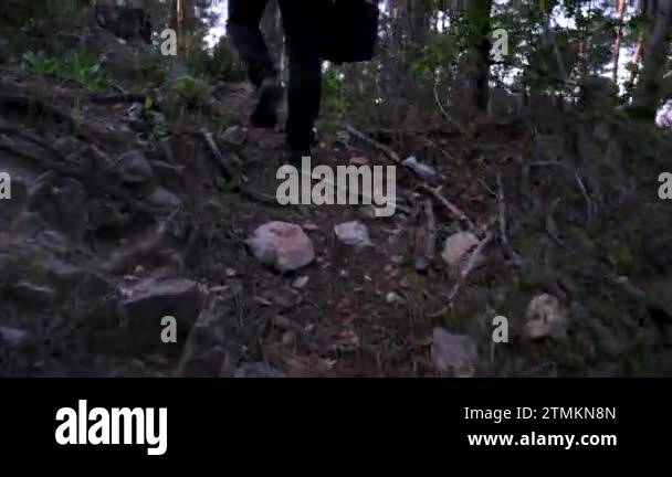 Hikers feet walking in the mountain forest. Man walking in the woods ...