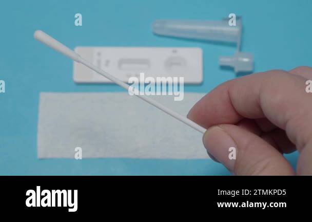 POV of Man hands using Rapid antigen test kit or ATK and blue ...