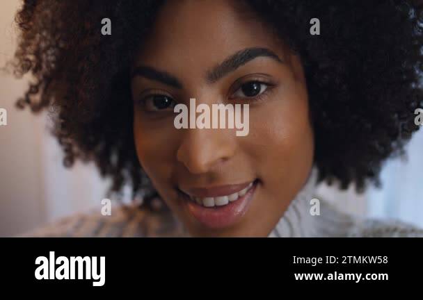 Portrait curly model laughing indoors. Brown eyes happy woman staring ...