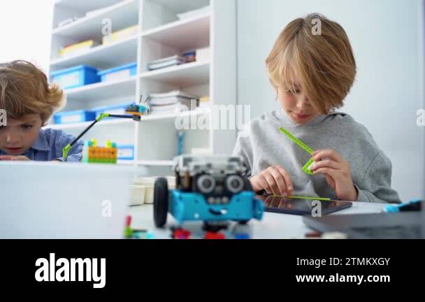 Robotics programming class. Children construct and code Robot. STEM ...