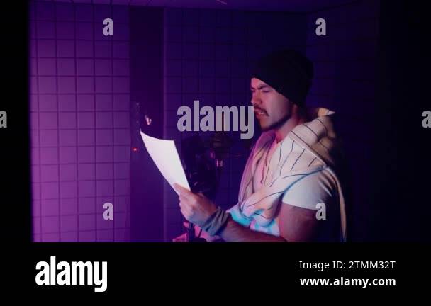 voice actor is re-recording in isolation booth of audio record studio ...