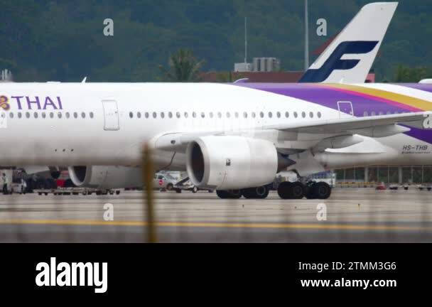 PHUKET, THAILAND - NOVEMBER 26, 2017: Passenger airliner towing, side ...
