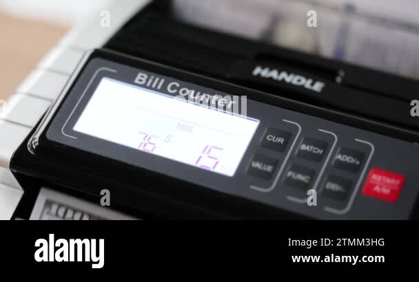 Electronic money counter machine counts one hundred dollar US dollars ...