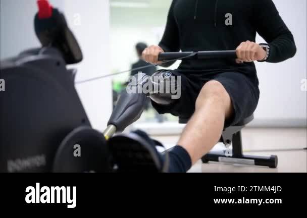 Disabled athlete with physical disability doing exercise routine indoor ...