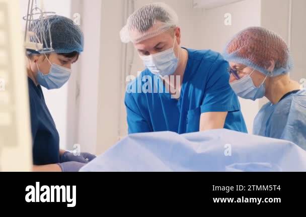 Doctor and assistant of the venous vascular surgery clinic during leg ...