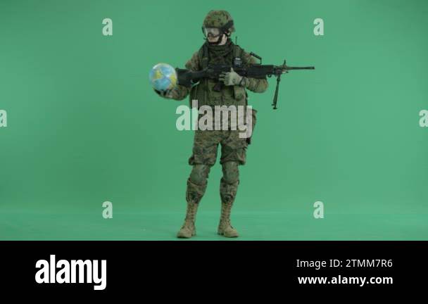 Soldier throwing up globus at green screen Stock Video Footage - Alamy