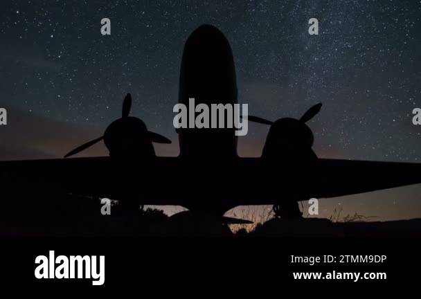 Stars sky turning over vintage military aircraft time lapse. Night sky ...