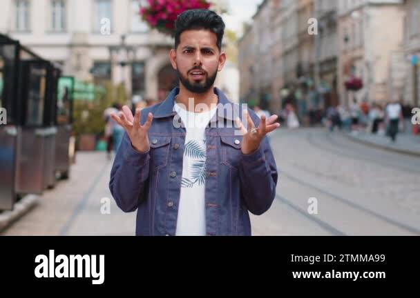 What. Why. Surprised frustrated young indian man raising hands asking ...