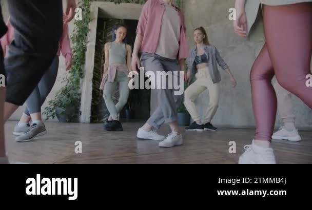 Creative dance group learning new moves enjoying practice in ...